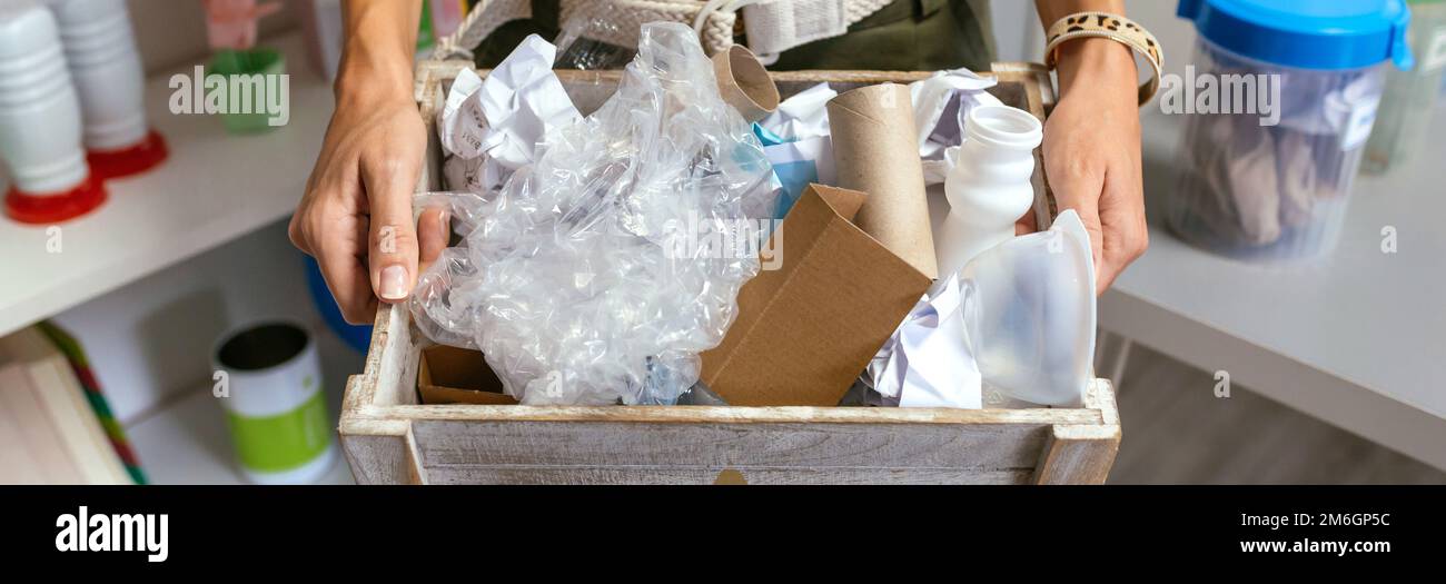 Female teacher showing a box of waste to recycle in ecology classroom ...