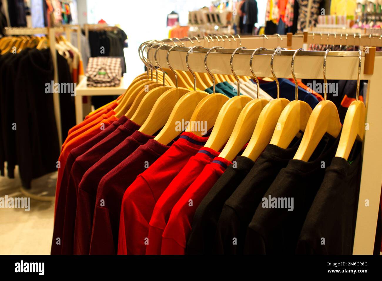 Shirt and pant hanging on hangers on a clothing rack and arranged in ...