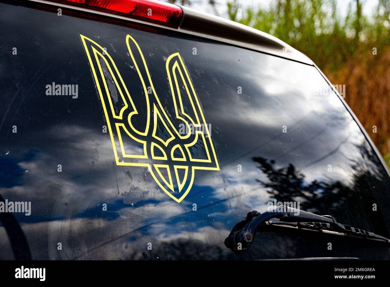 A sticker depicting the coat of arms of Ukraine is visible on the back ...