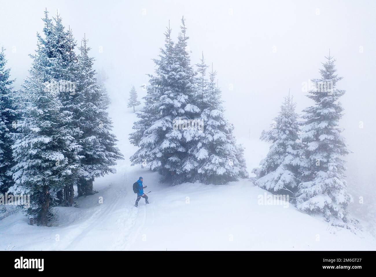 Tourist exploring the mountains near lake Bohinj after snow storm in ...