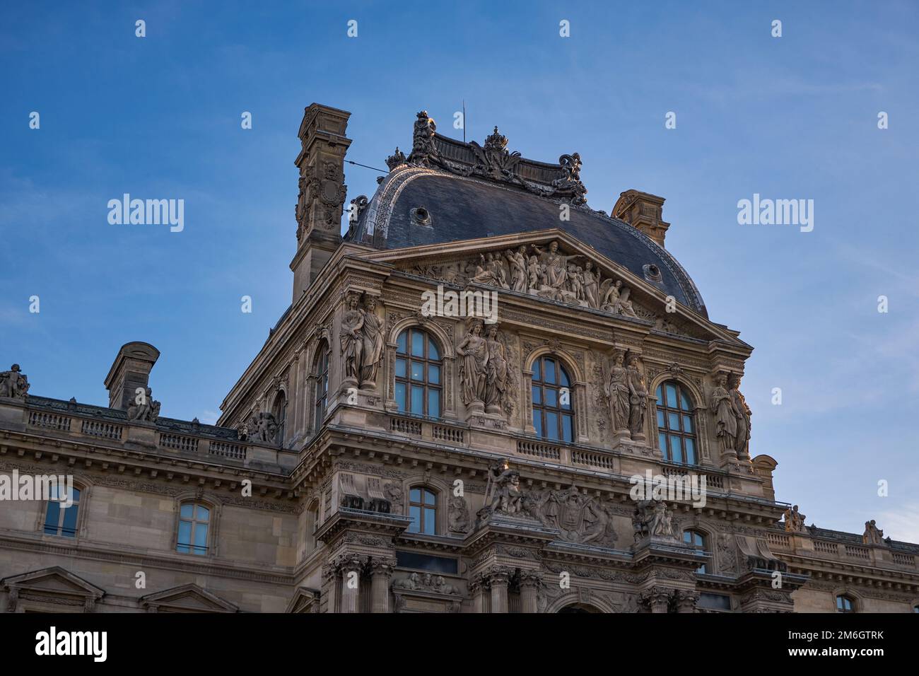 View of famous Louvre museum at sunset. The most visited museum ...