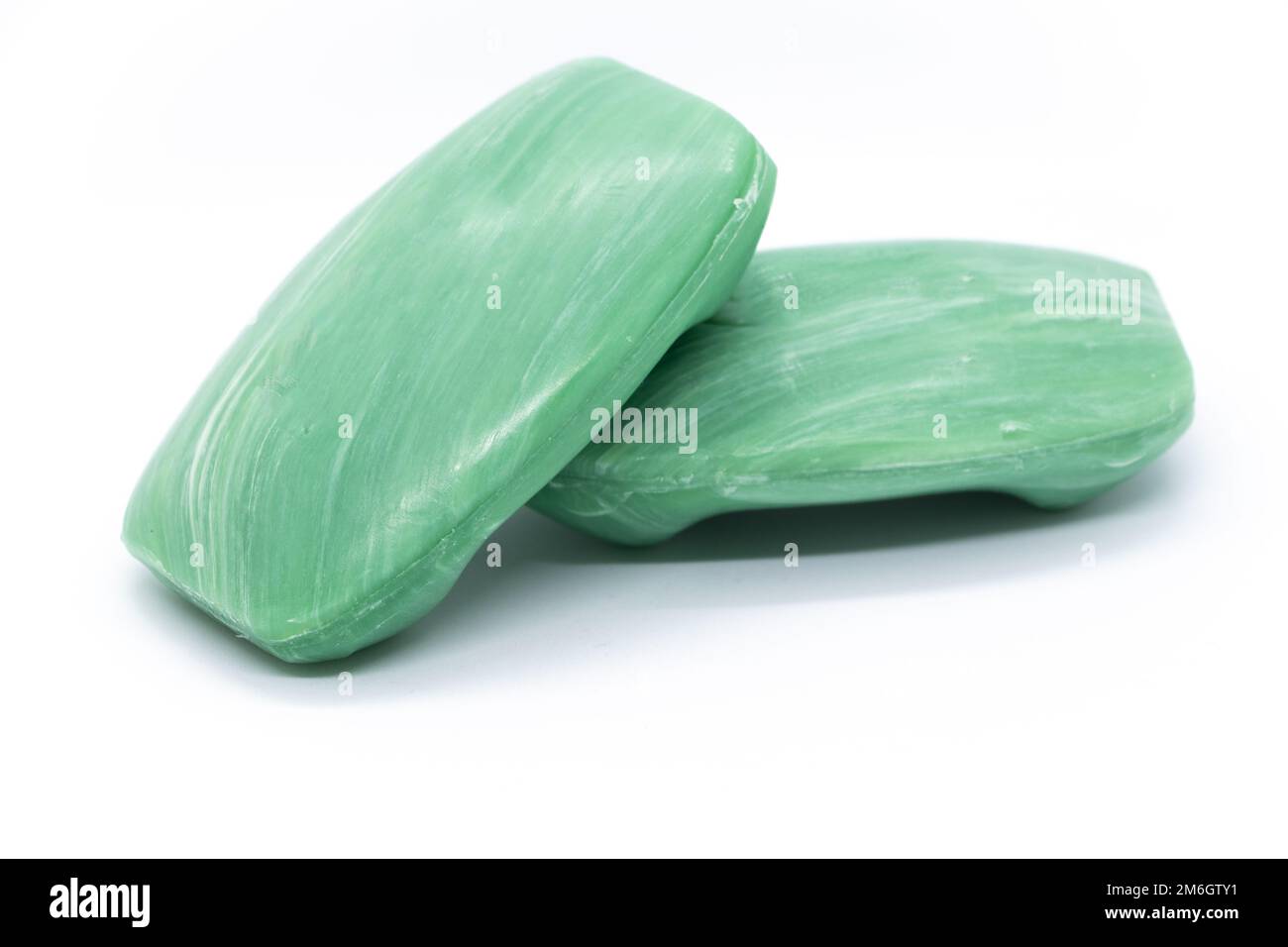 2 bars of green soap on white background Stock Photo - Alamy