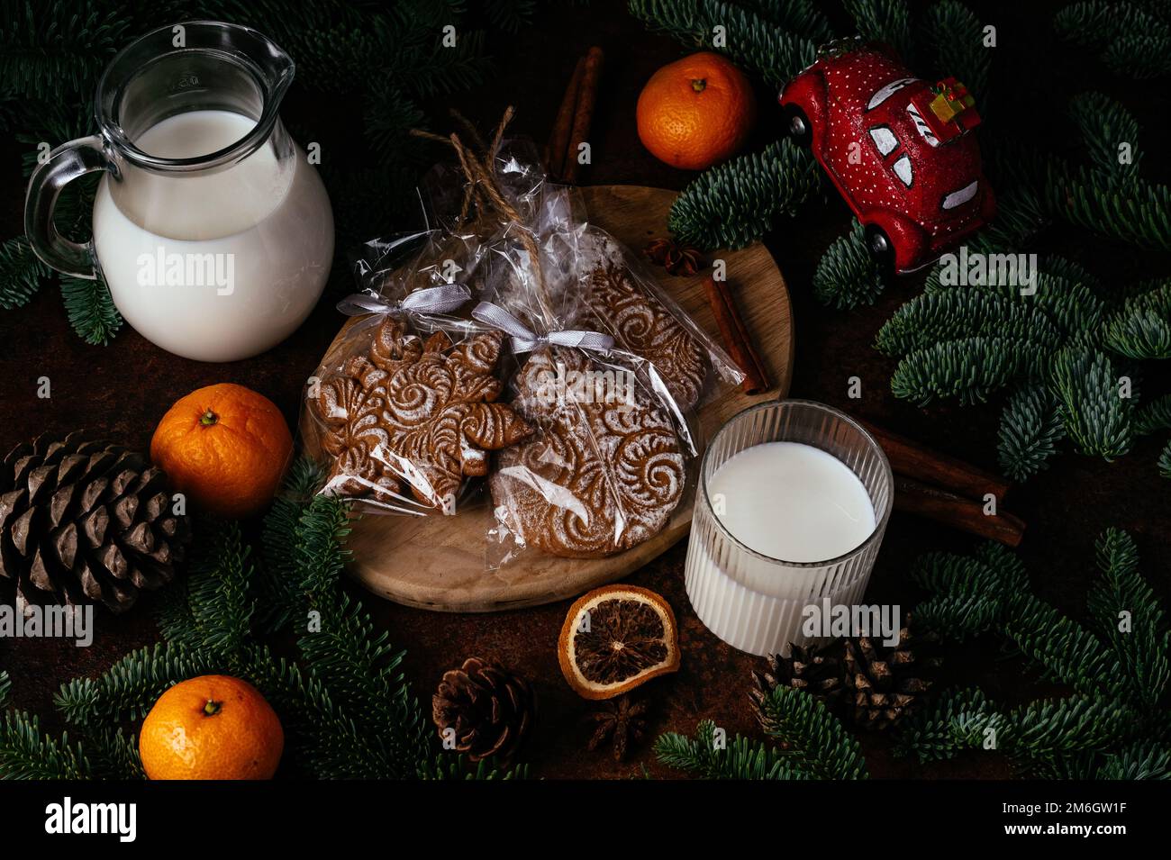 christmas table with gingerbread , tangerines and milk Stock Photo - Alamy