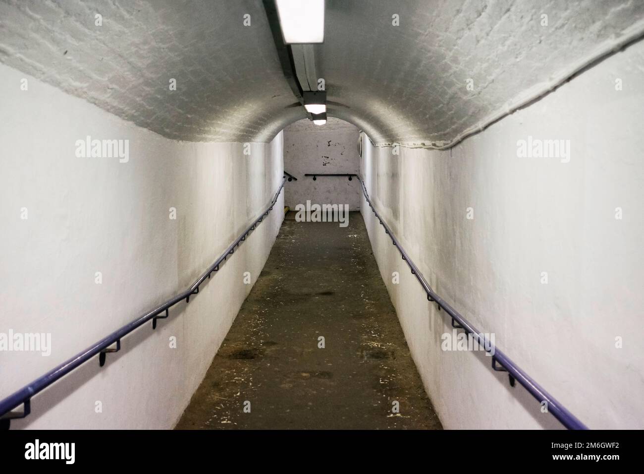 An empty underground subterranean railway station passage walkway Stock ...
