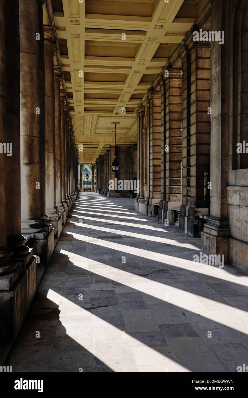 shafts of sunlight through columns create stripes of shadow and light ...