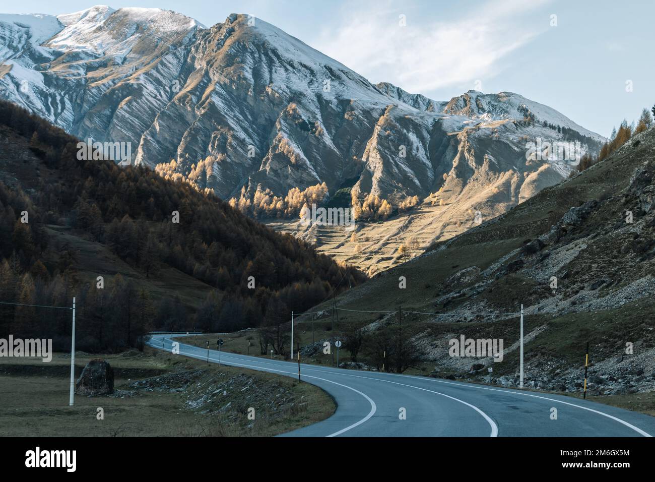 Empty asphalt road between Alps Stock Photo - Alamy