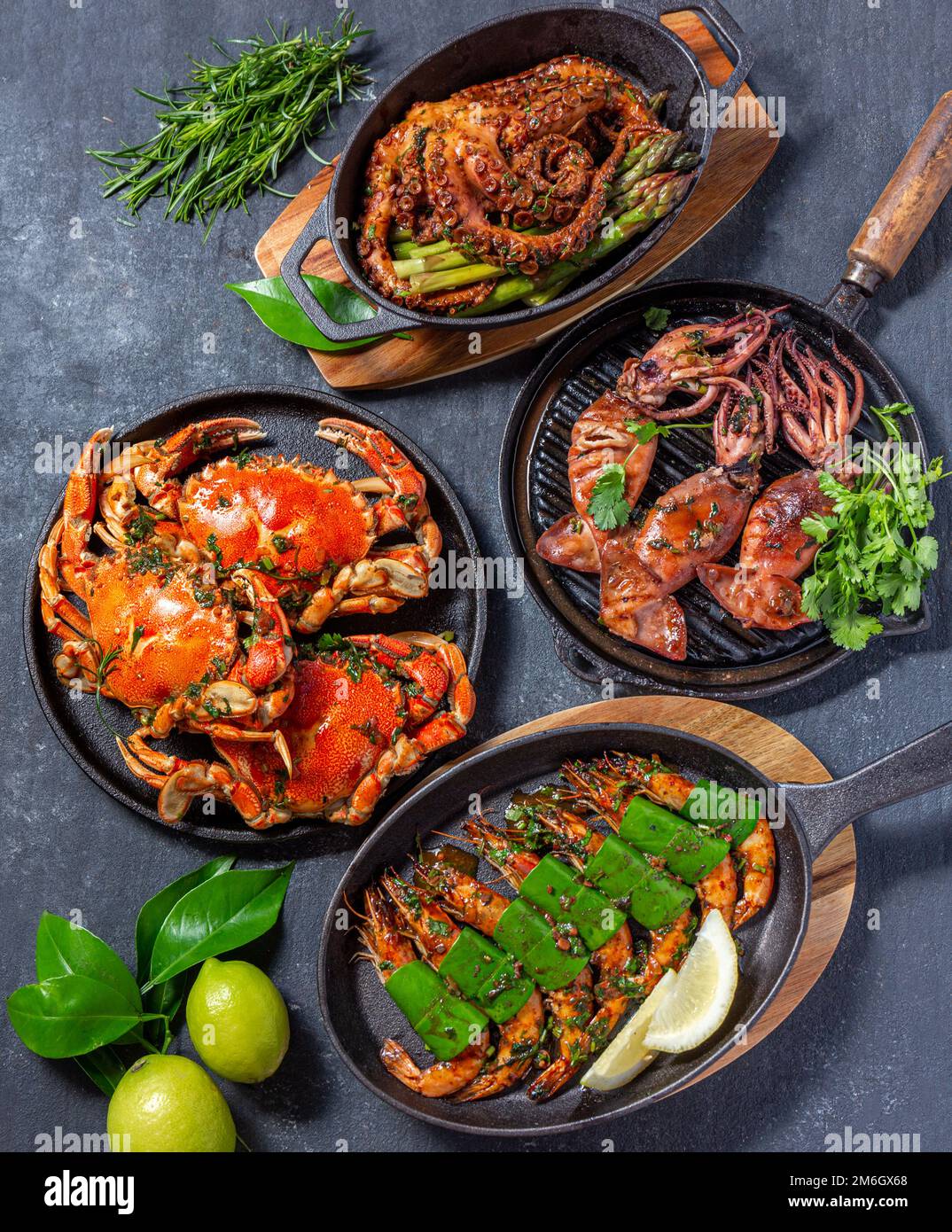 Set of Seafood Dishes. Crabs, octopus, squids and tiger shrimps on cast ...