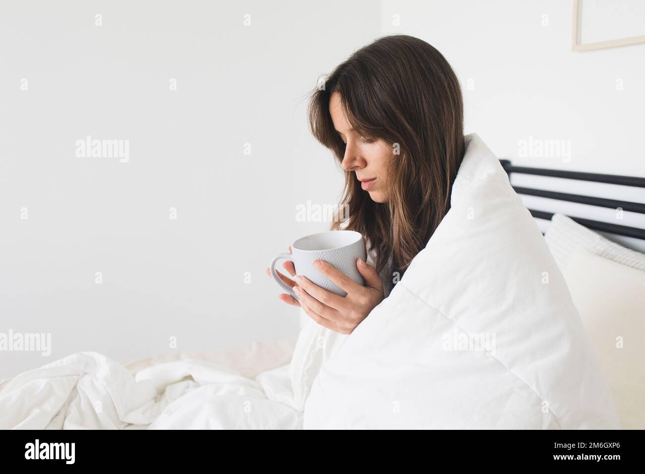 Woman Feeling Cozy in Bed Drinking Coffee Stock Photo - Alamy