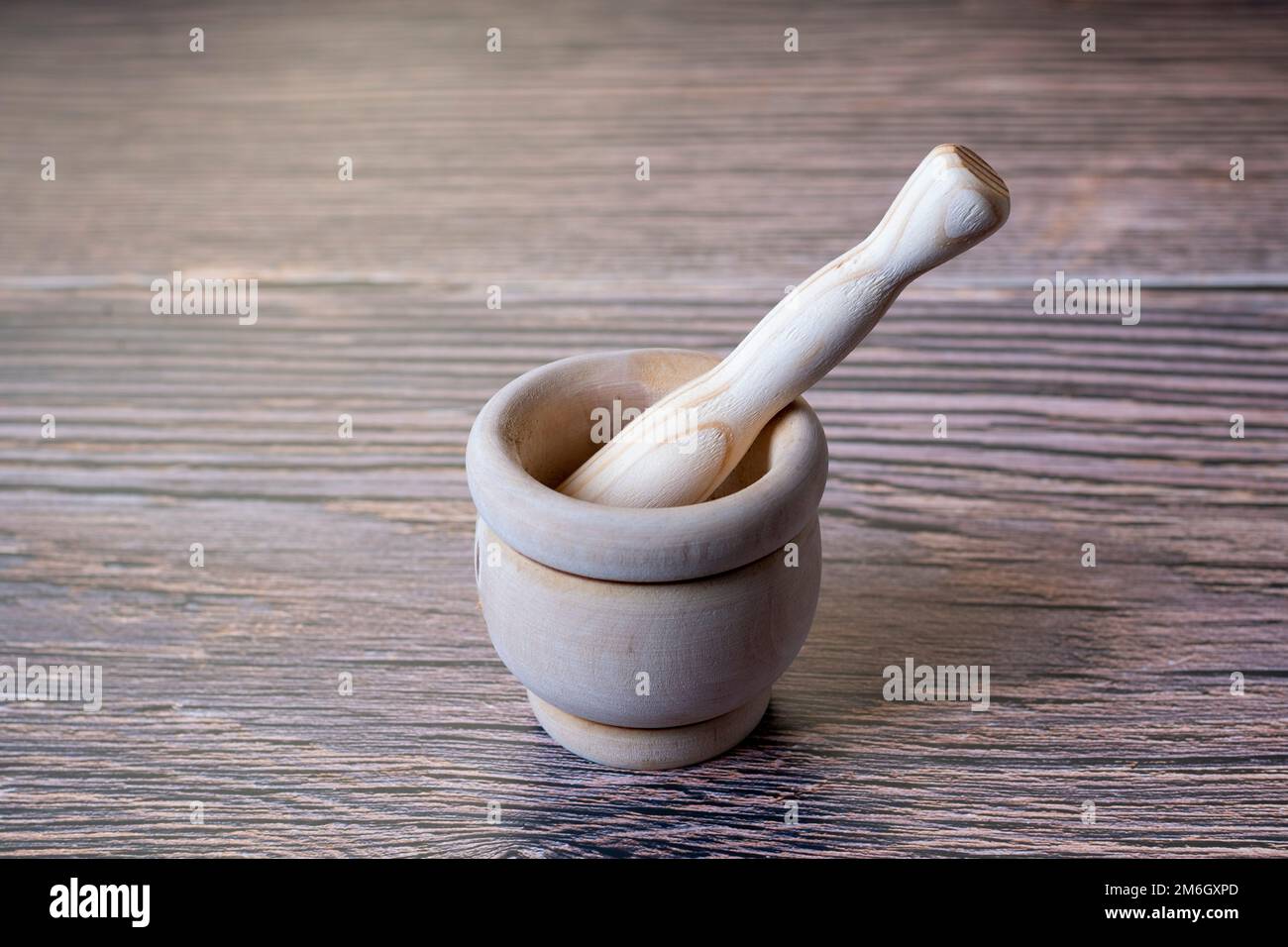 wooden mortar and pestle isolated on wooden Stock Photo - Alamy