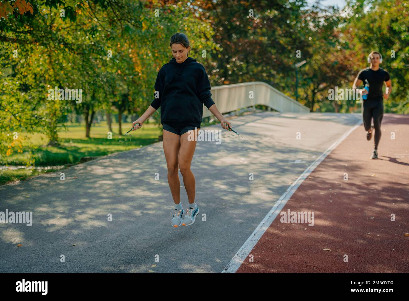 A male sportsperson is running a marathon around the park while ...