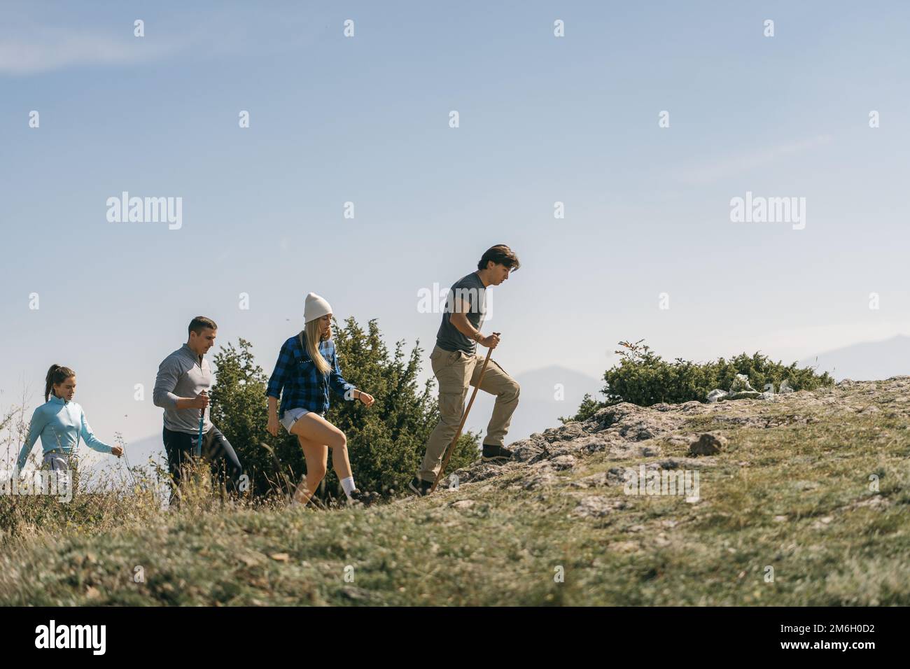 Four hikers walking on mountain hi-res stock photography and images - Alamy