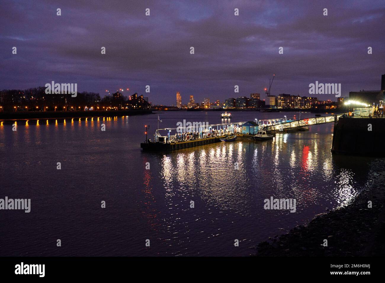 Greenwich river ferry pier on the River Thames in London at night Stock ...