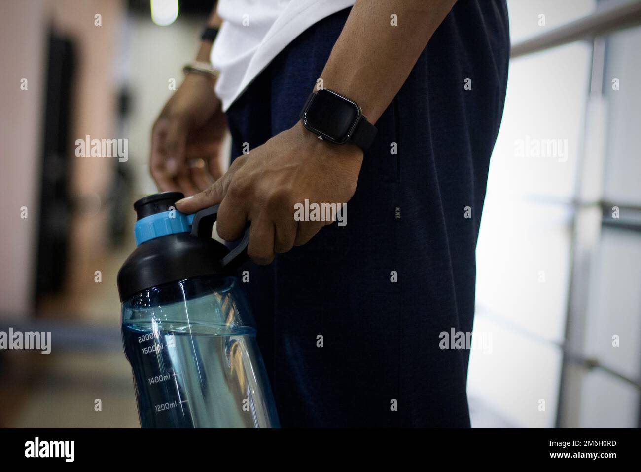 Strong muscle man closeup doing exercise in gym weightlifting equipment ...