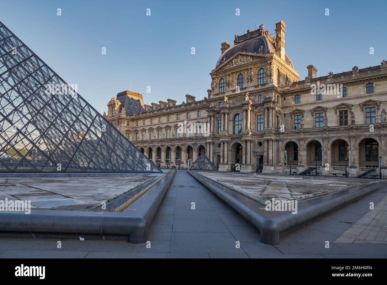 View of the famous Louvre museum and glass Pyramid at sunrise. The most ...