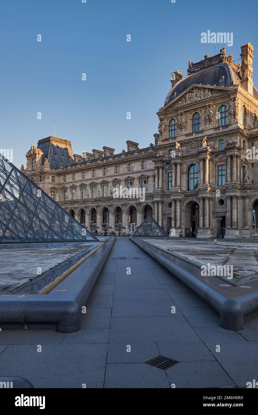 View of the famous Louvre museum and glass Pyramid at sunrise. The most ...