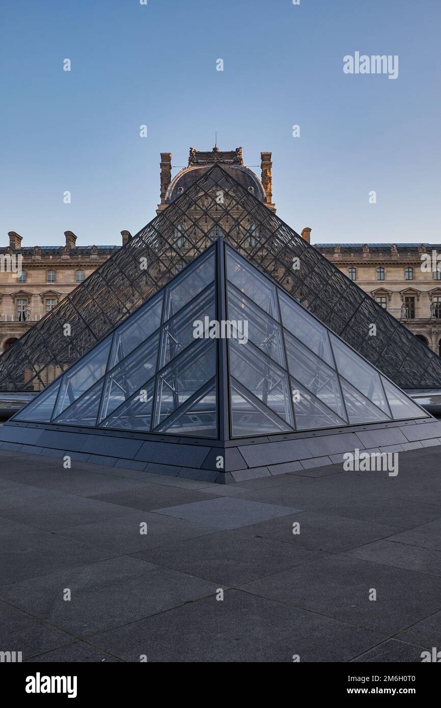 View of the famous Louvre museum and glass Pyramid at sunrise. The most ...