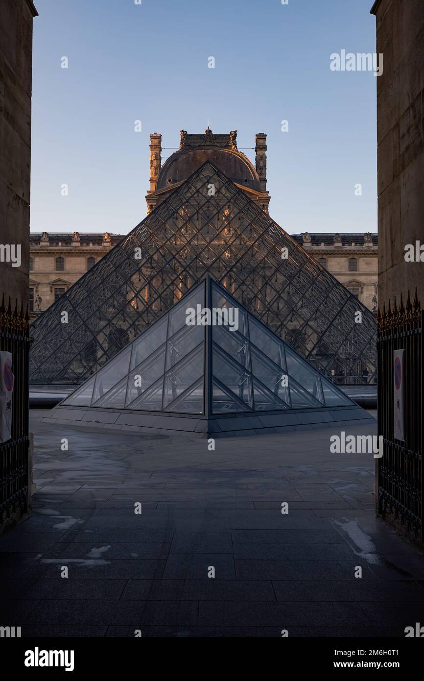 View of the famous Louvre museum and glass Pyramid at sunrise. The most ...