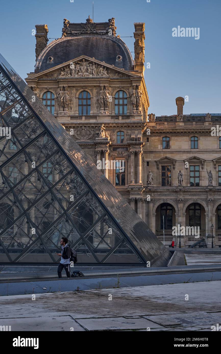View of the famous Louvre museum and glass Pyramid at sunrise. The most ...