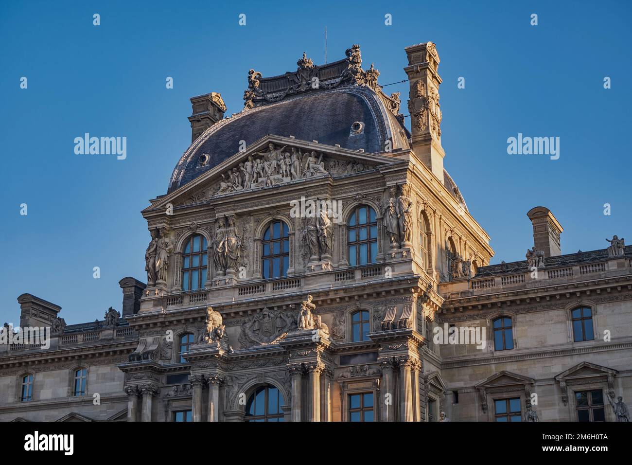 View of the famous Louvre museum at sunrise. The most visited museum ...