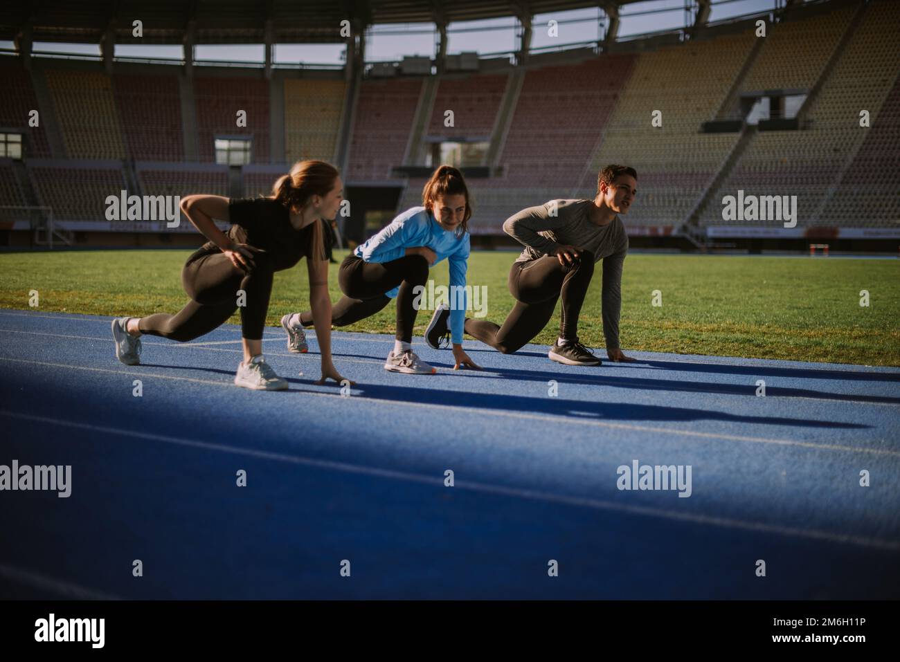 Beautiful friends are stretching their legs. They are about to jog ...