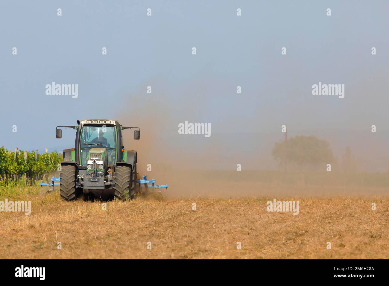 Agriculture, Fendt tractor ploughing a field during drought, Lake ...