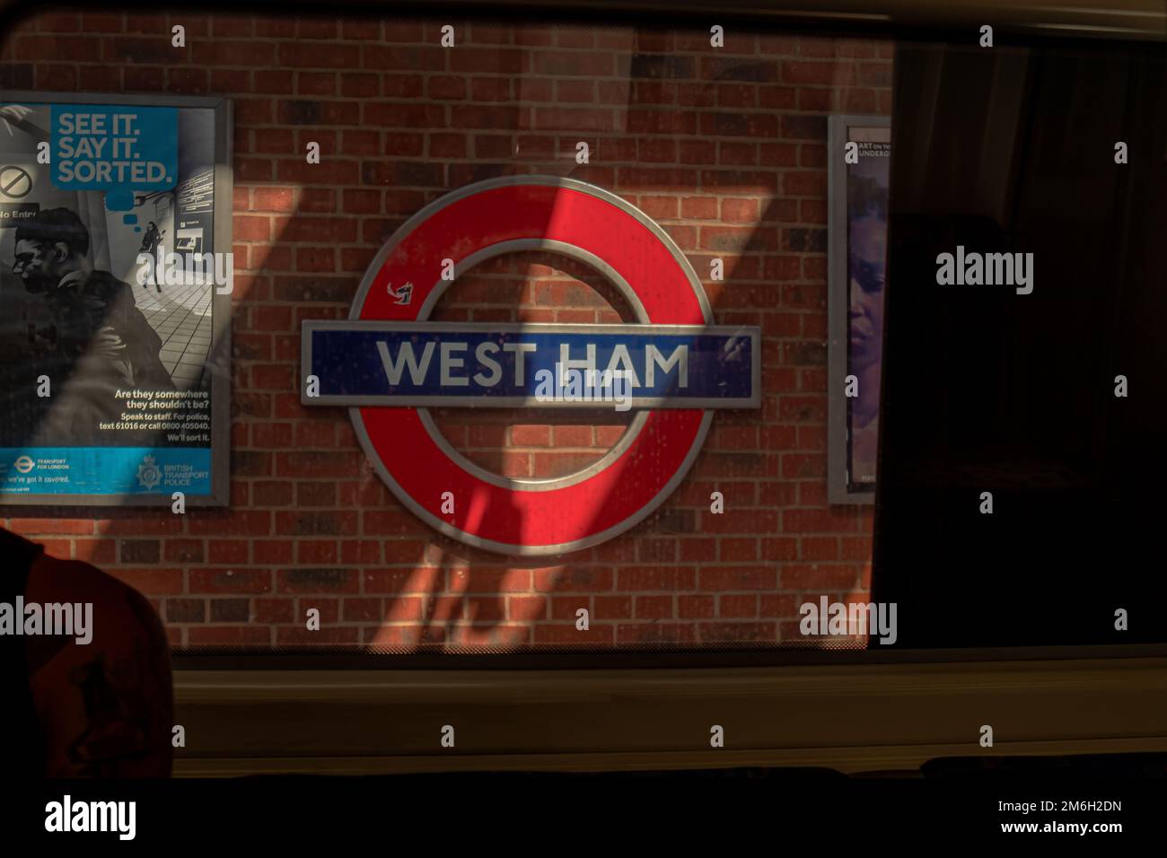 A closeup of a London underground sign of West Ham on a brick wall ...