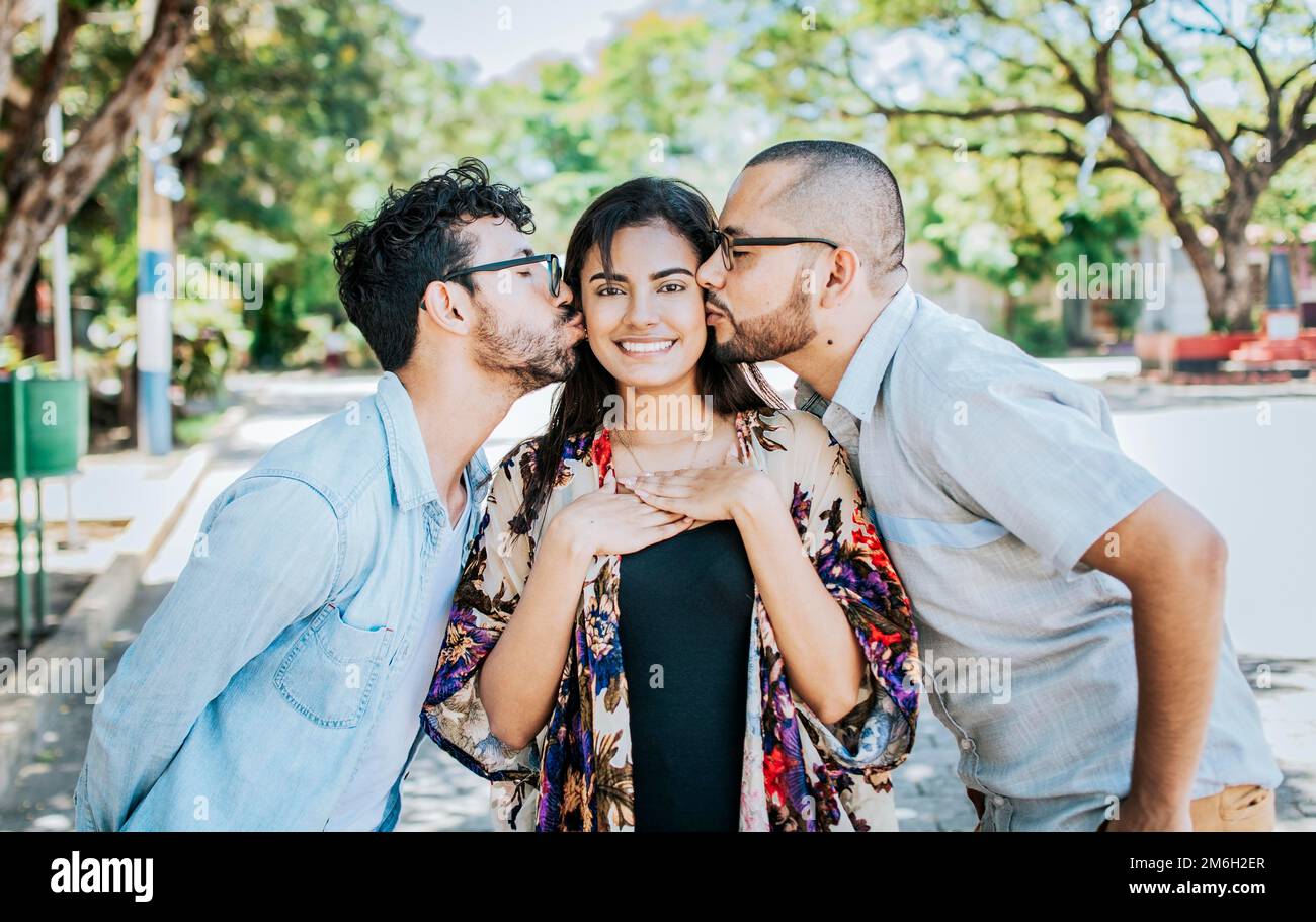 Two men kissing a girl cheek. Portrait of two guys kissing a girl cheek ...