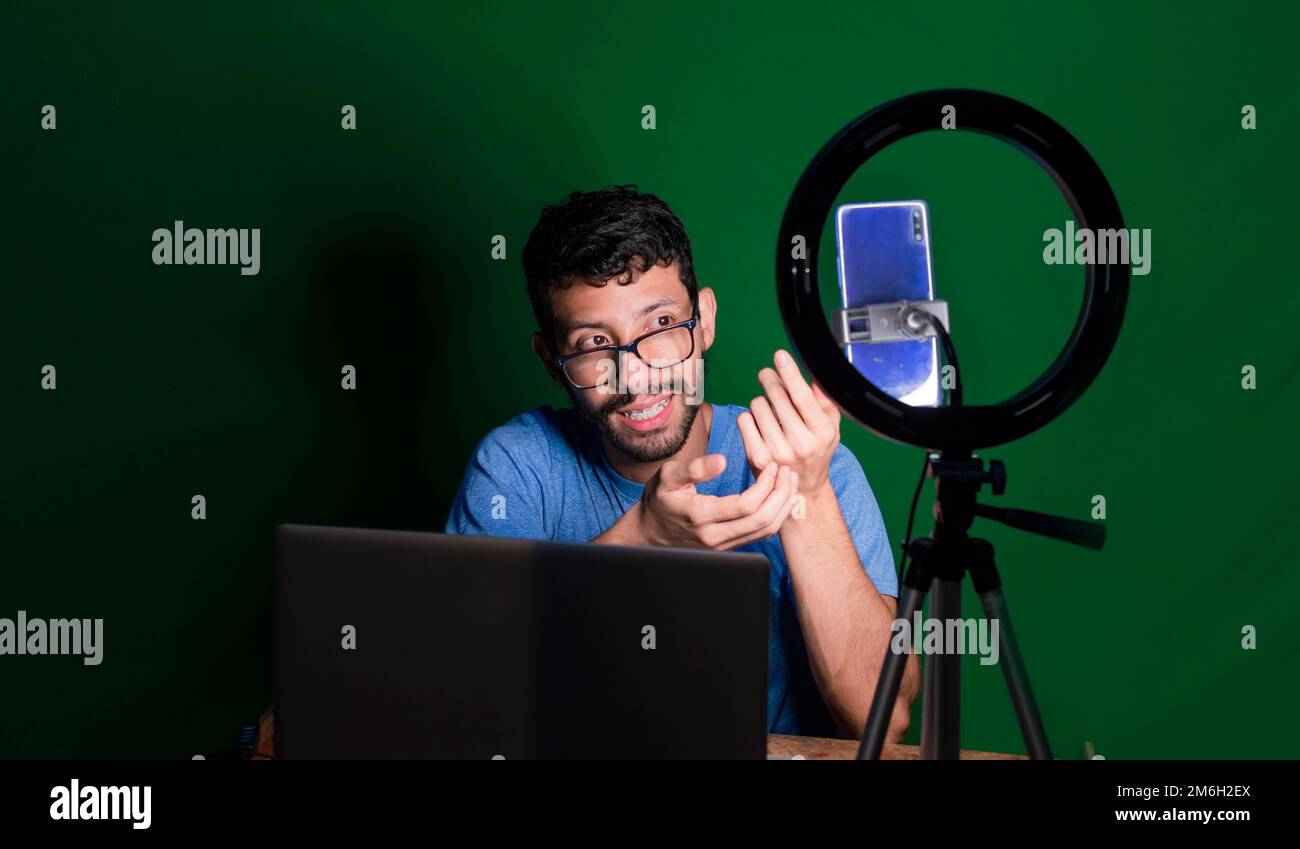 People giving online classes with phone. Guy with laptop making video ...