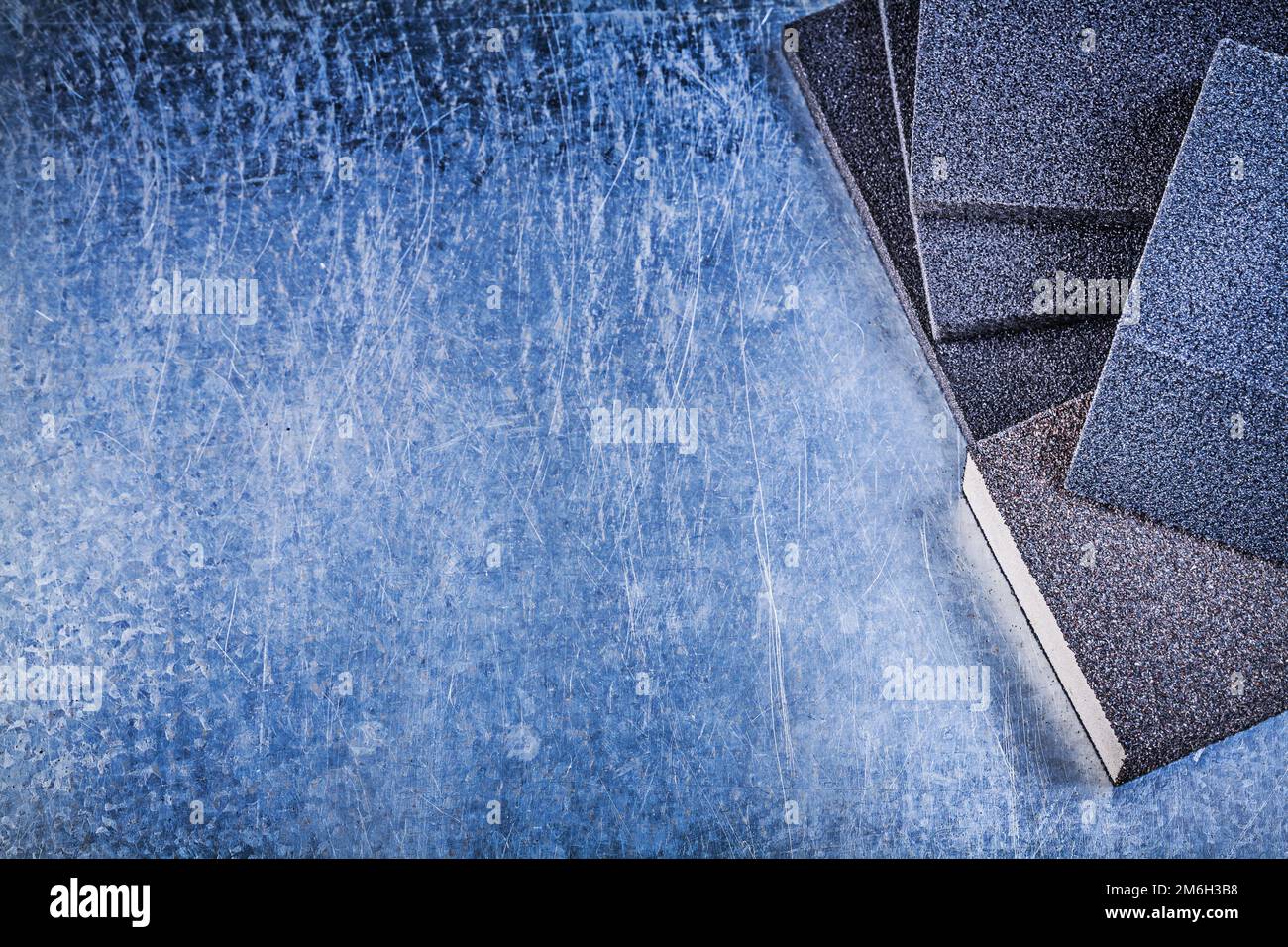 Abrasive sponges on scratched metallic background copy space Stock ...