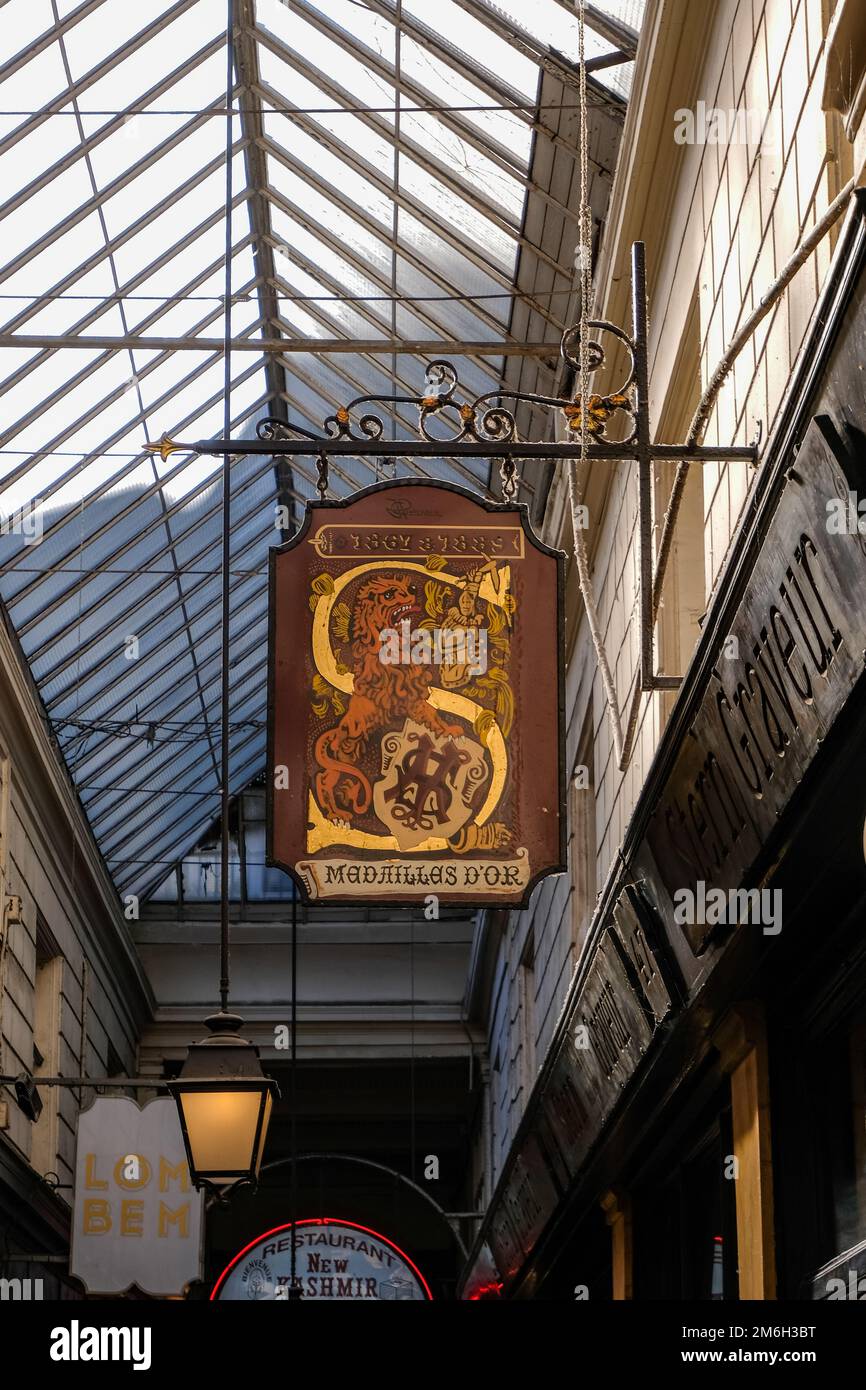 Vintage Shop Signs in a Covered Passage way with Glass and Iron Ceiling ...