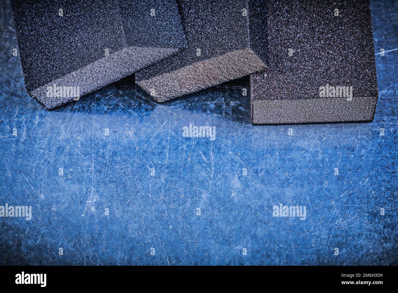 Abrasive sponges on scratched metallic background construction concept ...