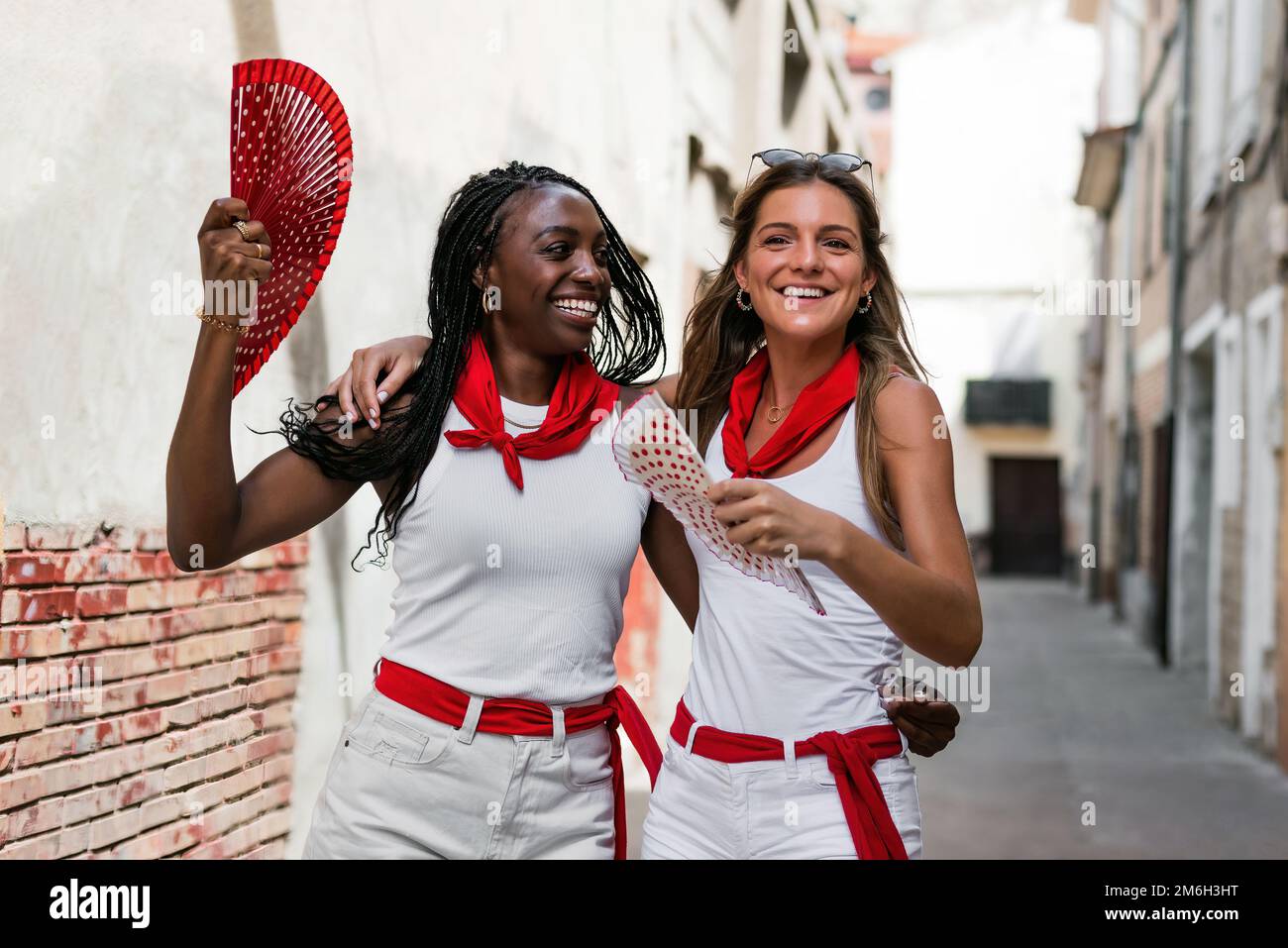 close-up of two young Caucasian and black girls enjoying the ...