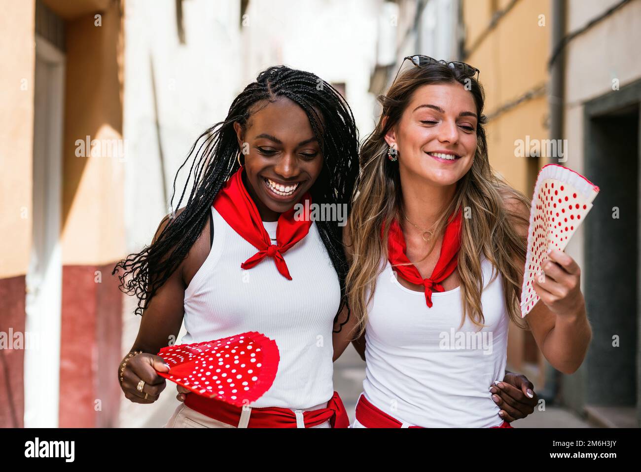 close-up two young caucasian and afro-american girls with their hand ...