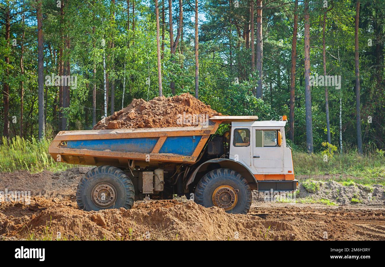 big old tipper vith clay ground standing in forest Stock Photo - Alamy