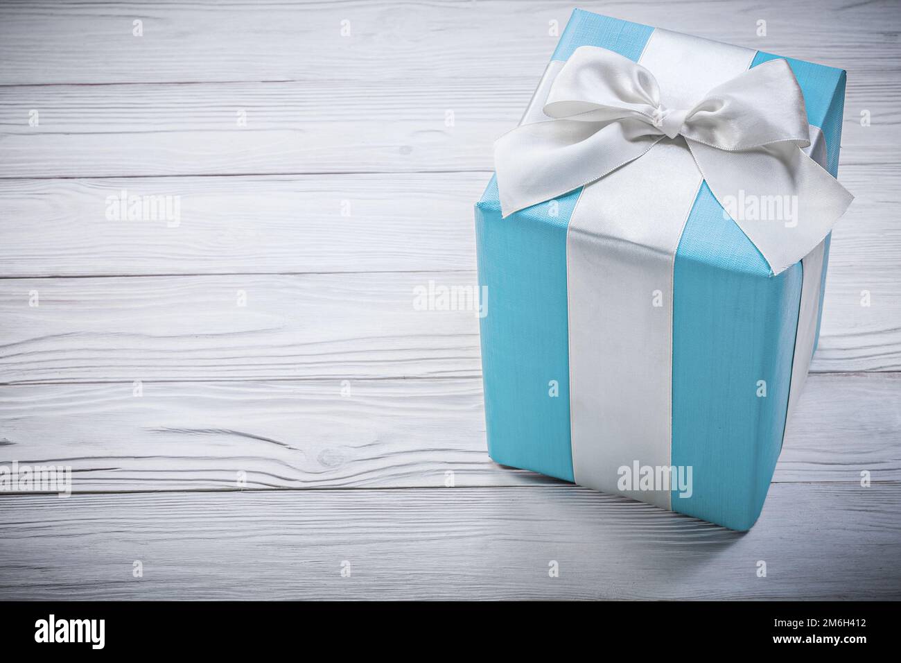 Blue gift box on wooden board celebrations concept Stock Photo - Alamy