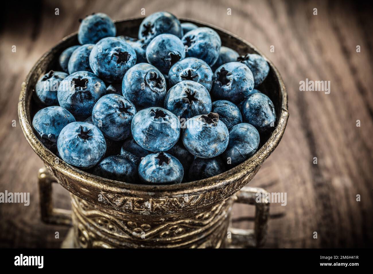 Blueberries in vintage metal bowl on grunge board Stock Photo - Alamy