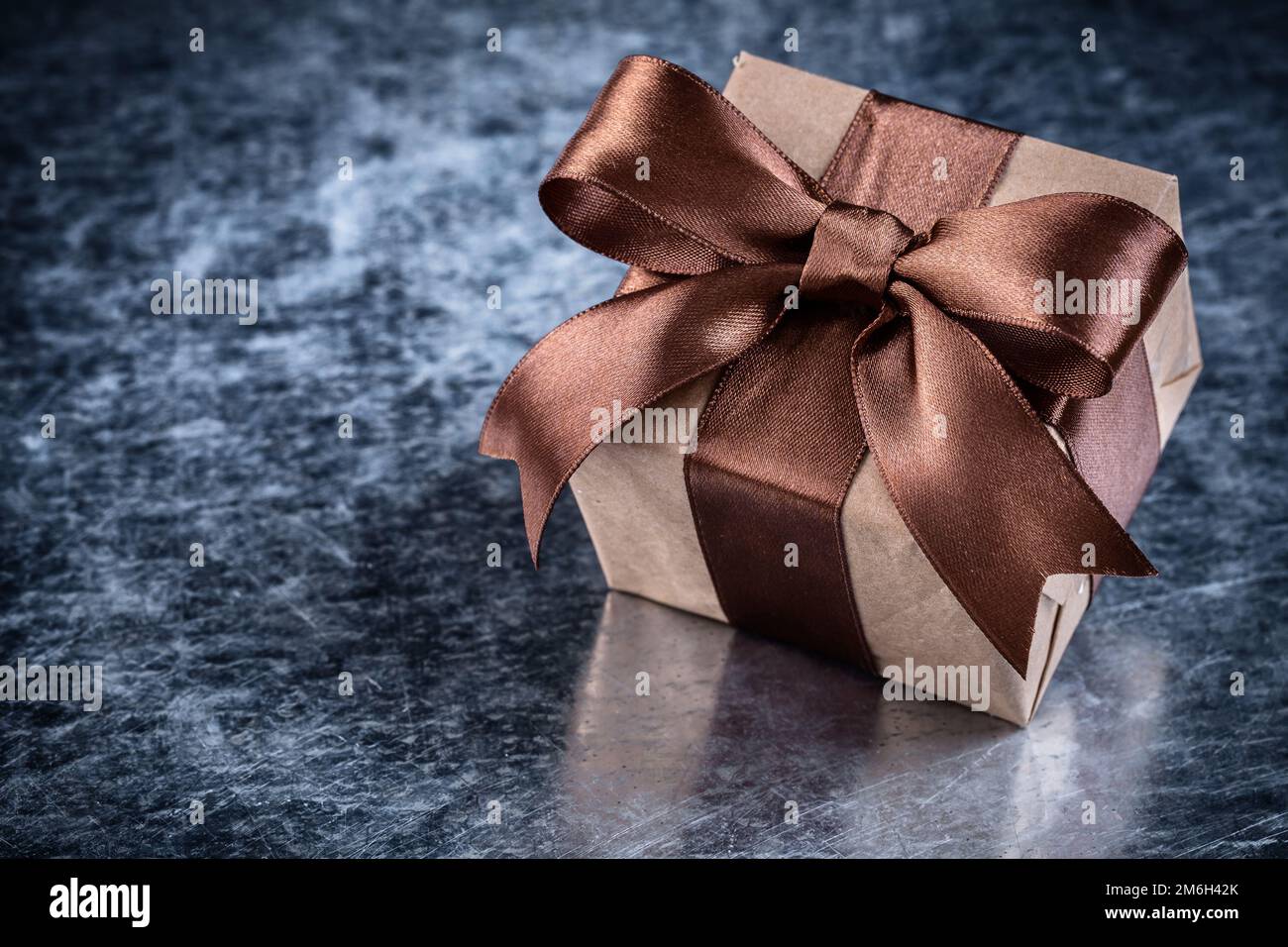Boxed gift with present tape on metallic background holiday concept ...