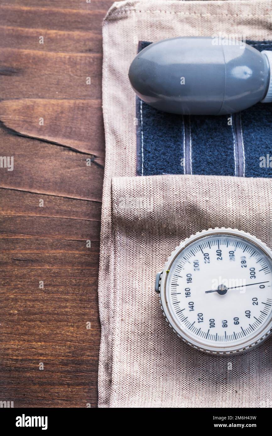 blood pressure monitor on vintage wooden board close up medical comcept ...