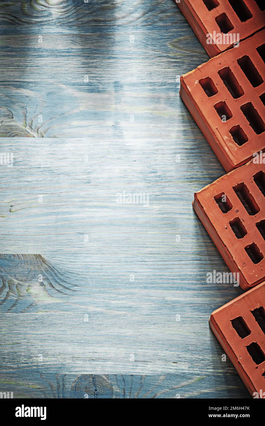 Building bricks on wooden board bricklaying concept Stock Photo - Alamy