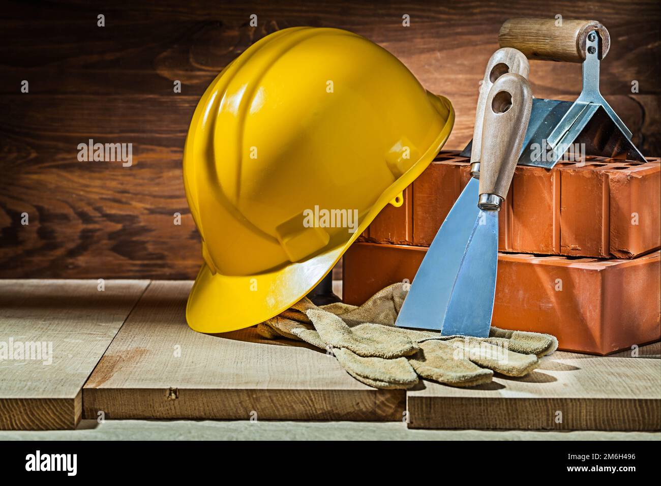 brick helmet gloves and trowels on vintage wood Stock Photo - Alamy