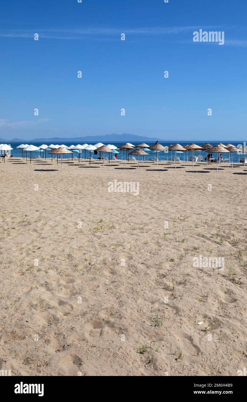 Straw parasols on the sandy beach on the Aegean Sea, Sarimsakli Plaji ...