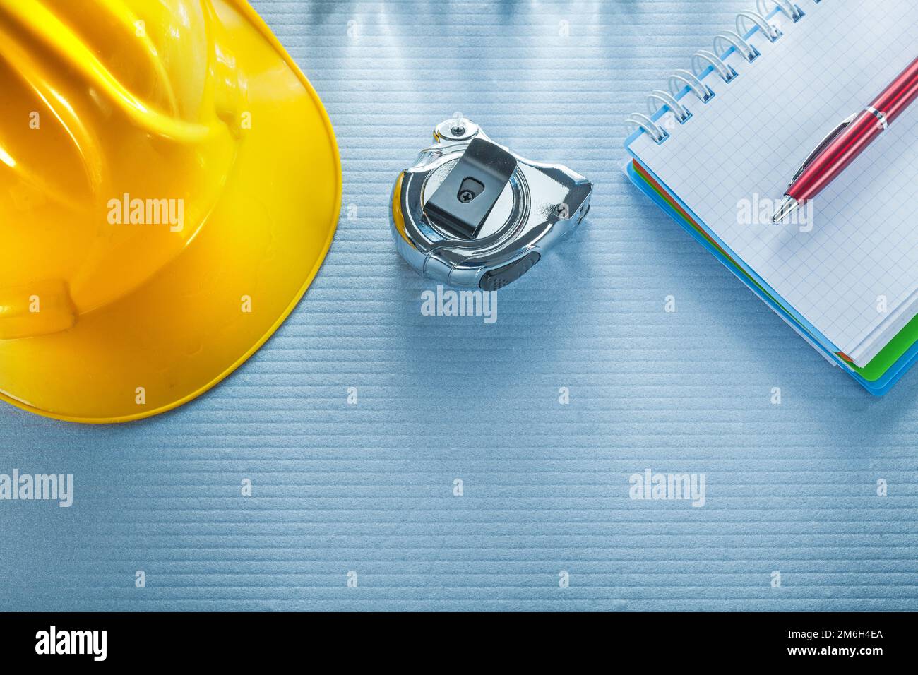 Checked notebook pen building helmet measuring tape Stock Photo - Alamy