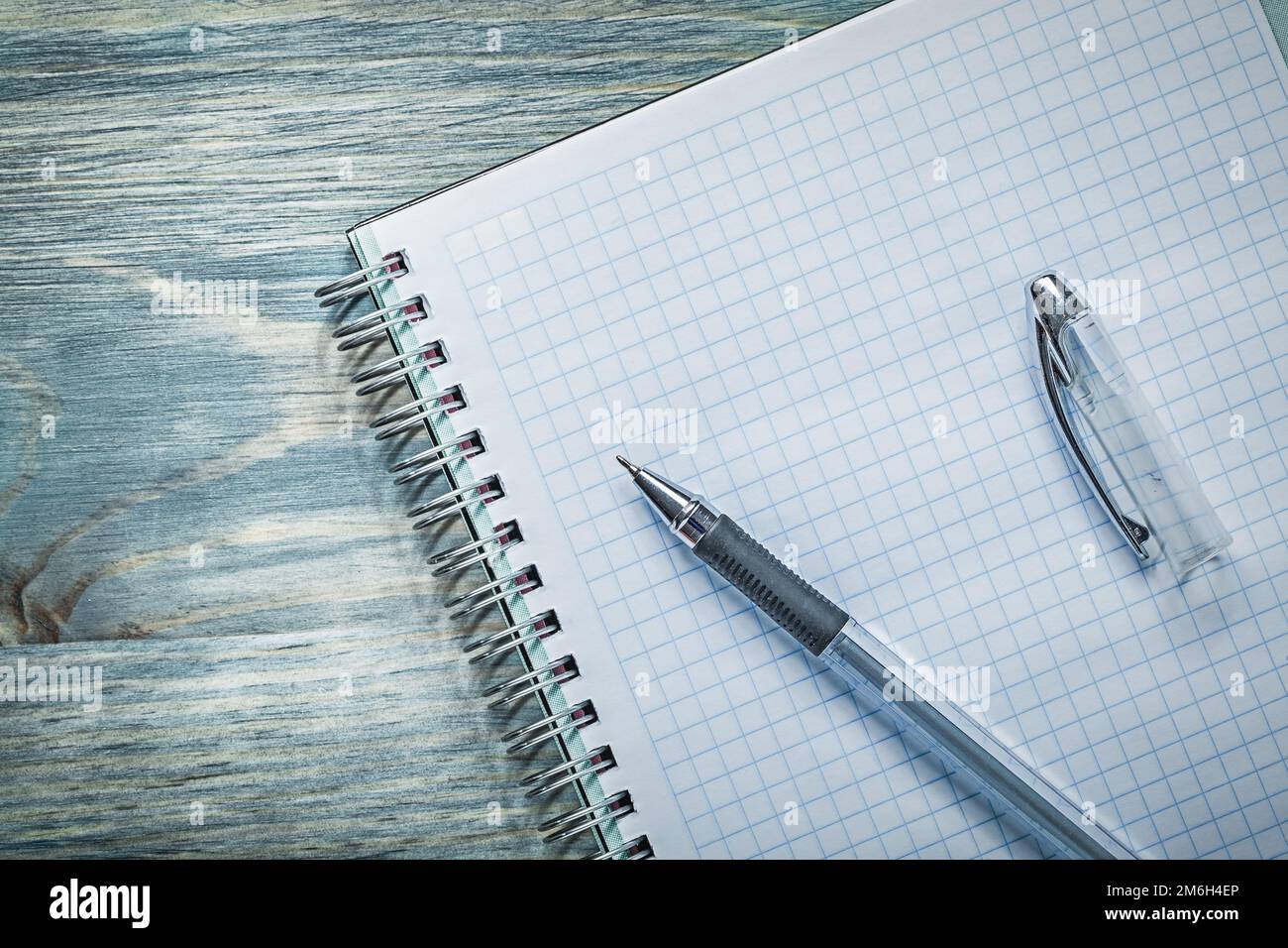 Checked copybook pen on wooden board office concept Stock Photo - Alamy