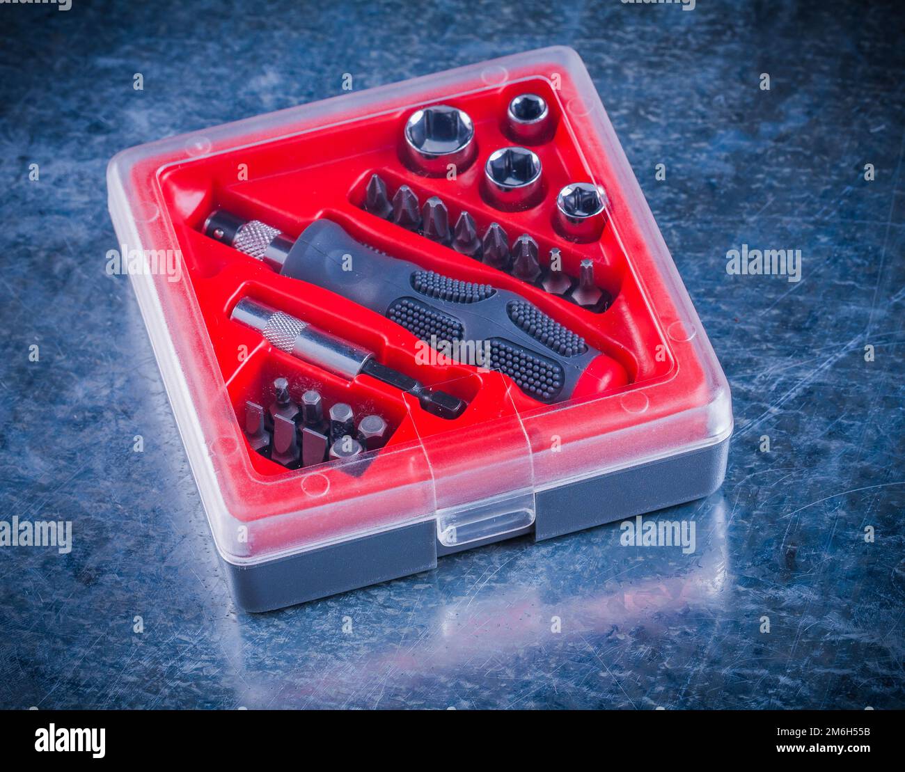 Closed toolbox with screwdriver and replaceable bits on metallic ...