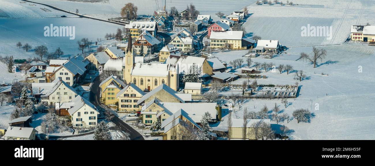 Village panorama with snow with church St. Martin, aerial view ...