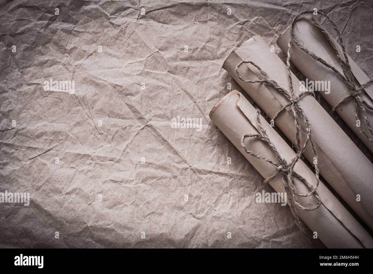 Heap of vintage paper rolls on crumpled wrapping sheet Stock Photo - Alamy