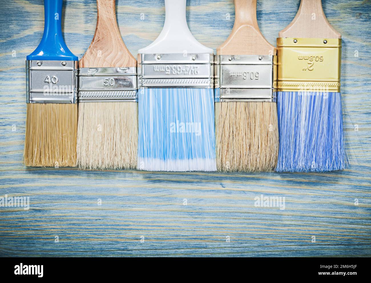 Horizontal image of paintbrushes on wooden board construction concept ...