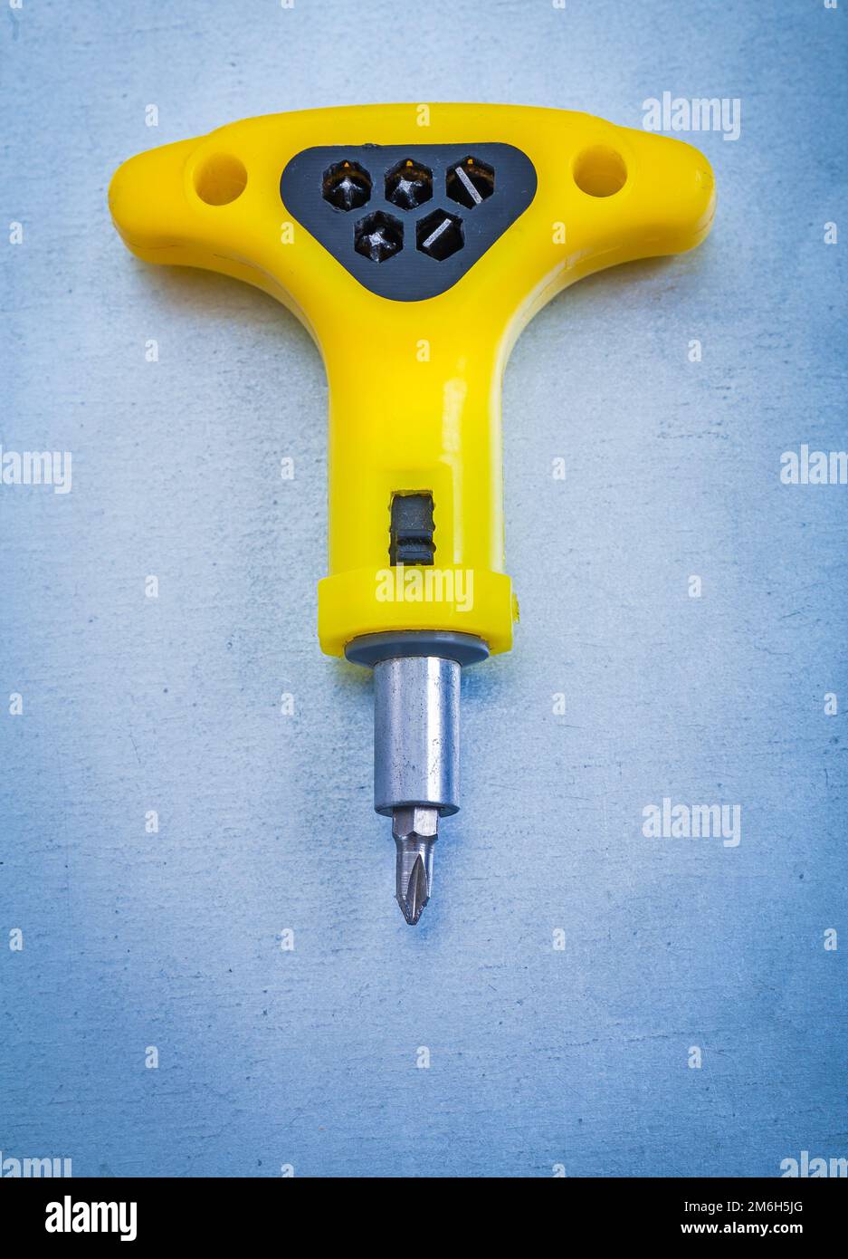 Insulated electric yellow screwdriver on metallic background ...