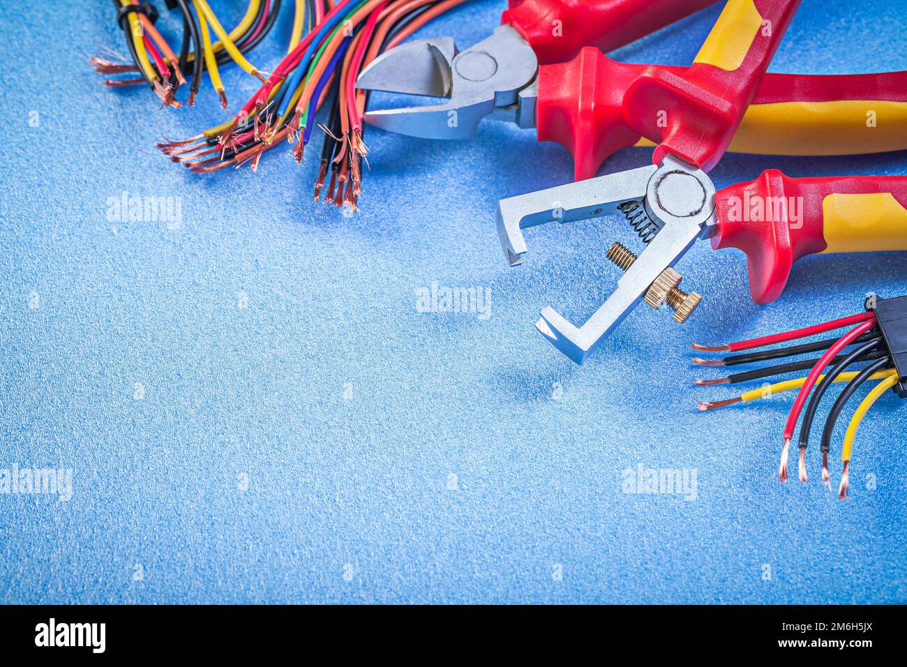 Insulation strippers set of electric wires cutting pliers on blue ...