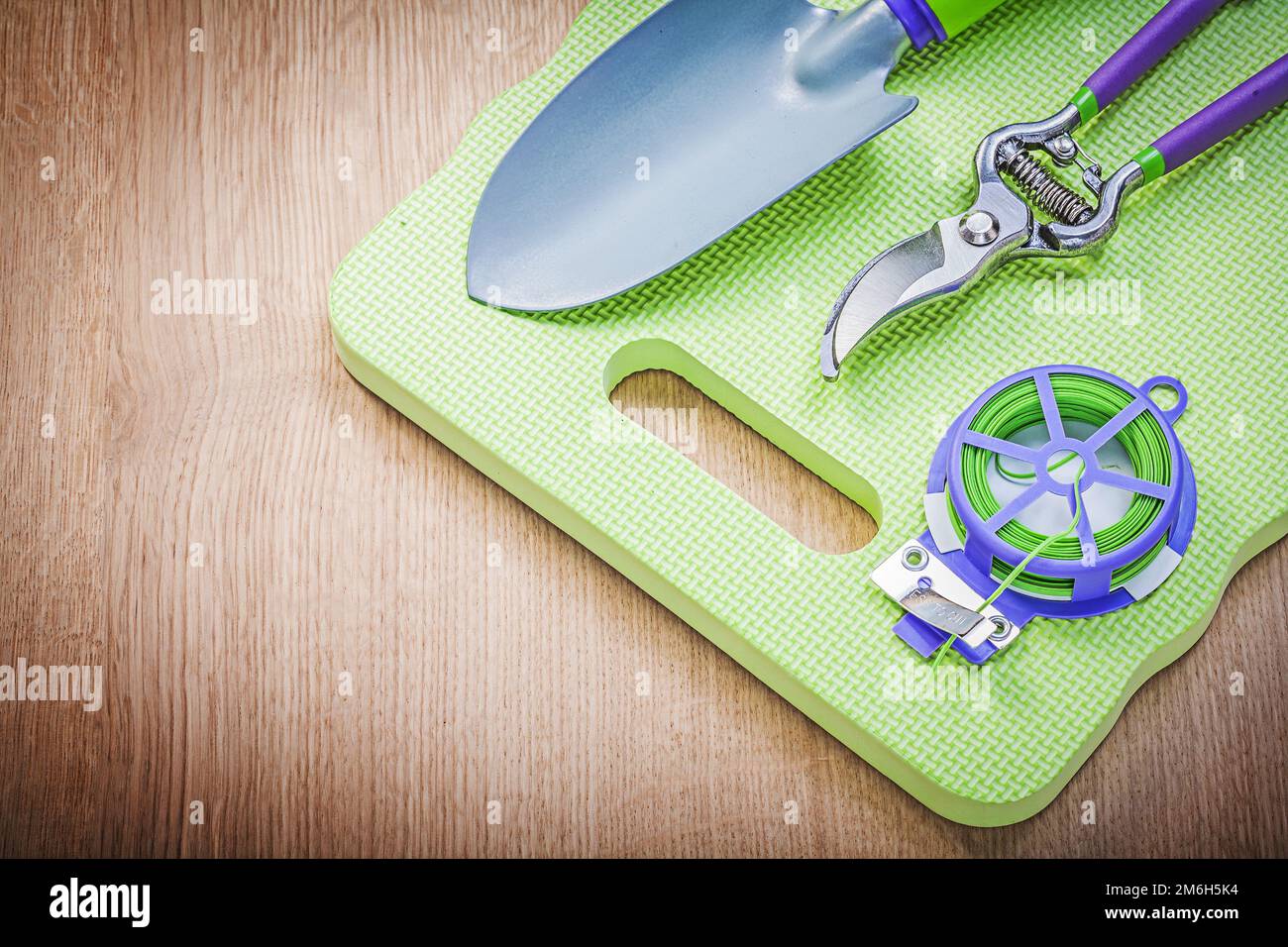 Kneeling pad hand spade garden pruner soft twist tie on wooden board ...